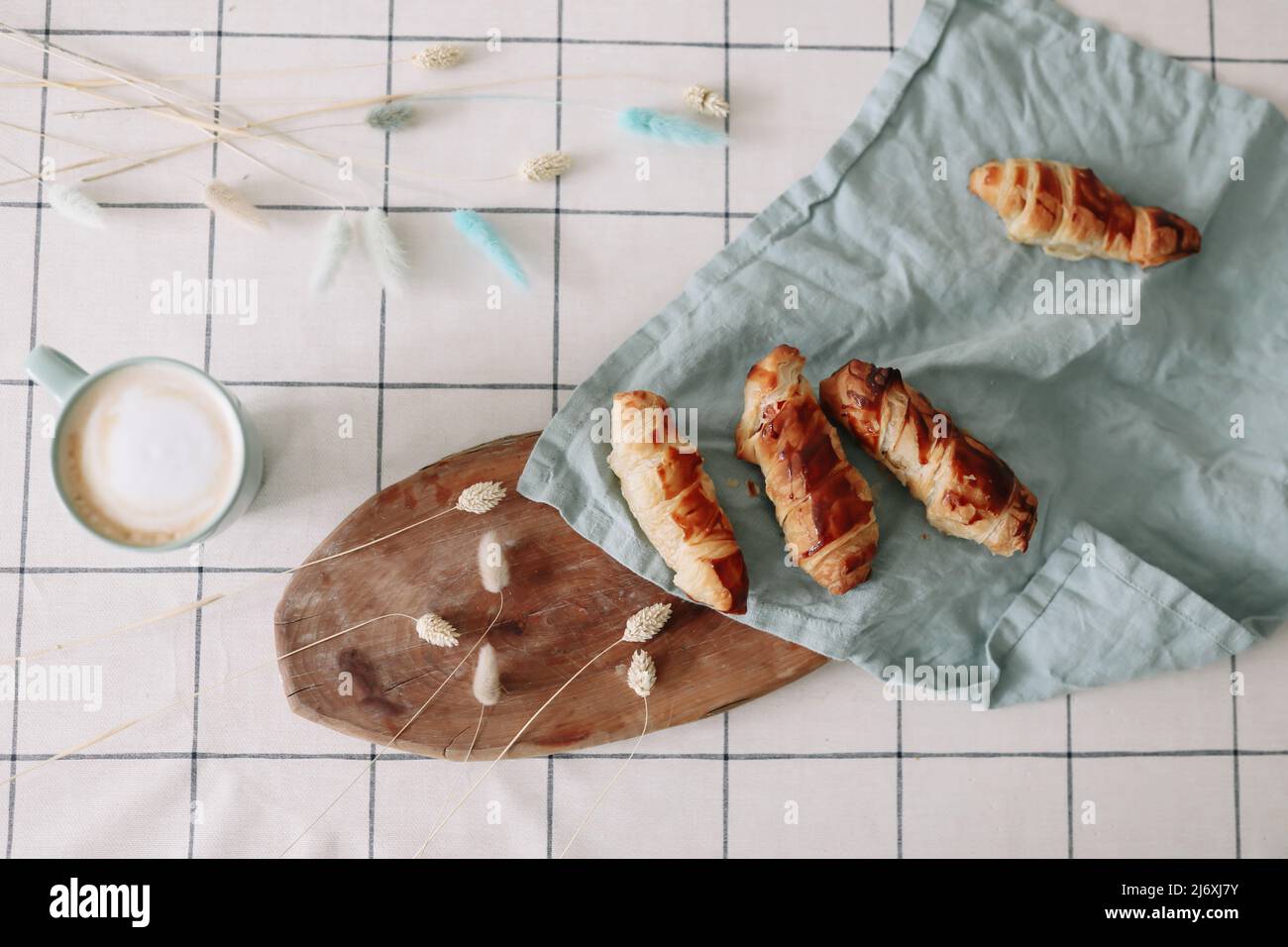 freshly baked homemade pastry on kitchen table. breakfast with coffee ...