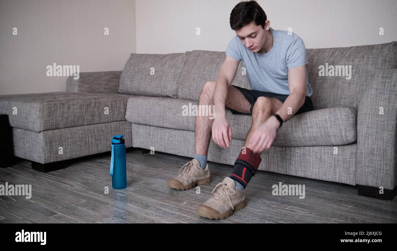The guy puts a compression bandage on the injured knee. Preparing for ...
