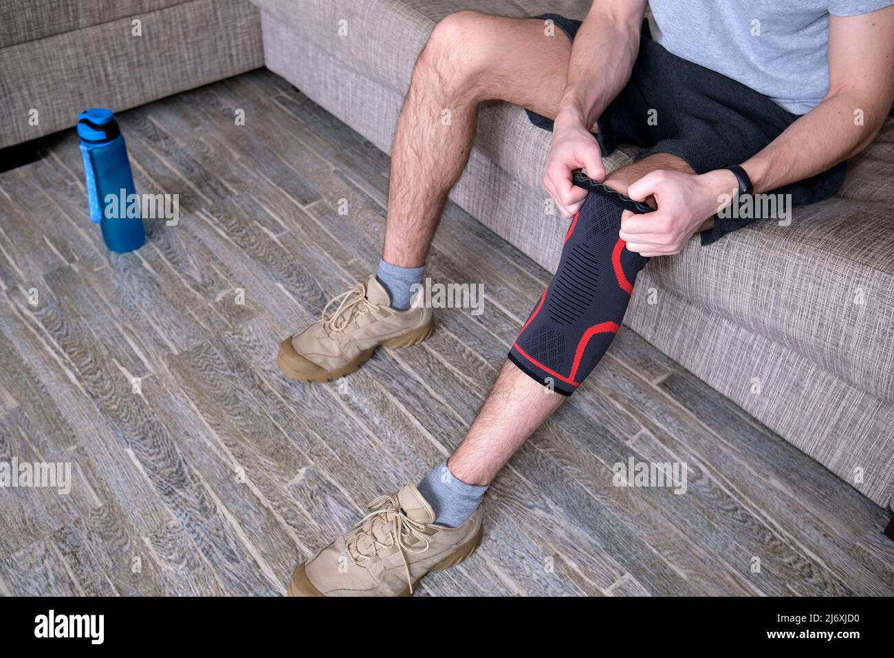 The guy puts a compression bandage on the injured knee. Preparing for ...