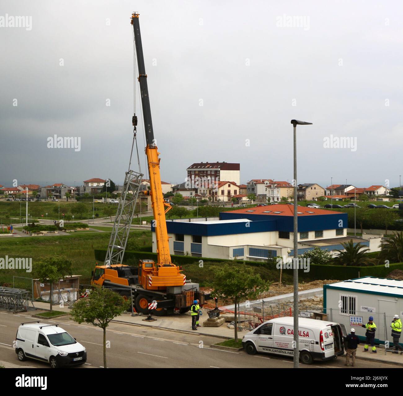 First section of the mast of a tower crane being lifted into position ...