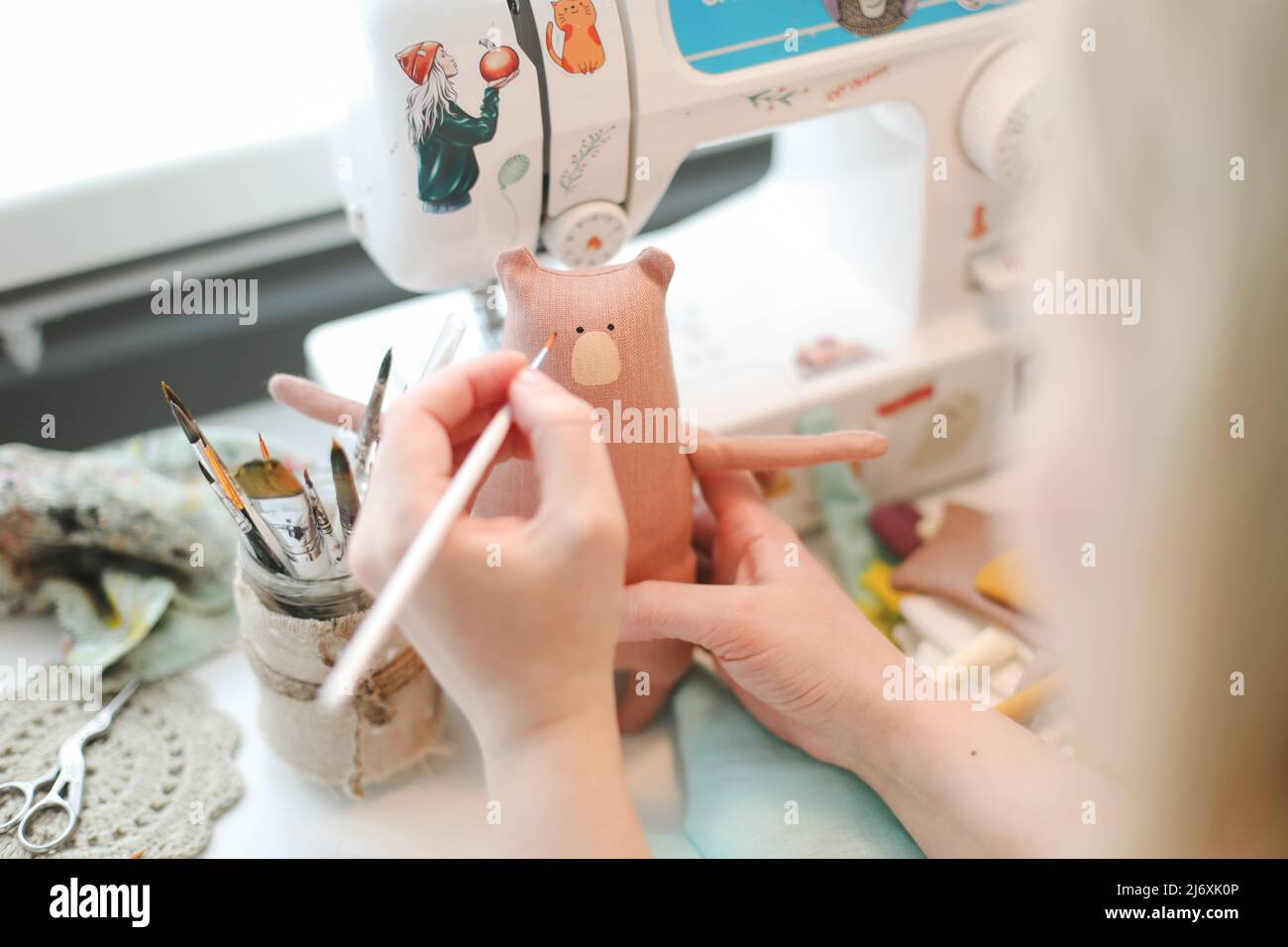 Process of making toy, top view. Woman hands making handmade teddy toy ...
