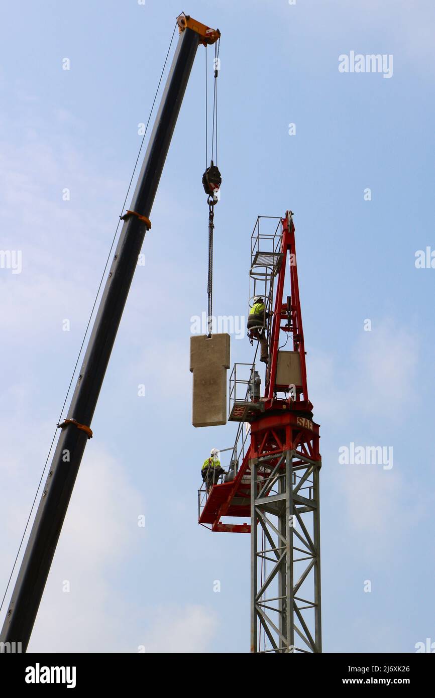 Concrete counterweight being lifted into position during the assembly ...