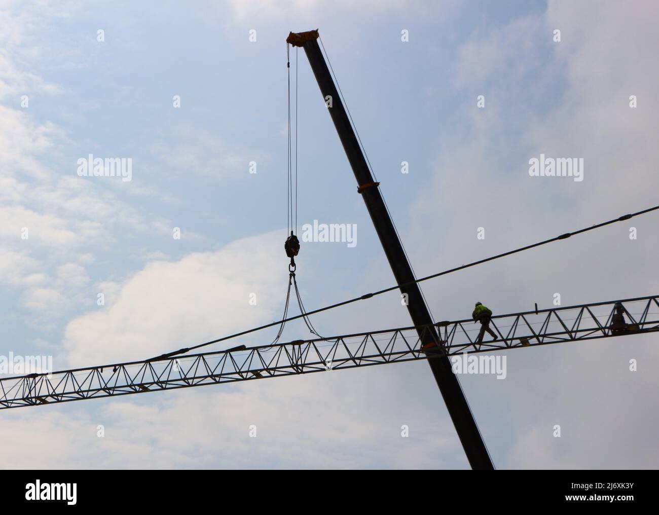 The horizontal jib of a crane suspended from the boom of a truck ...