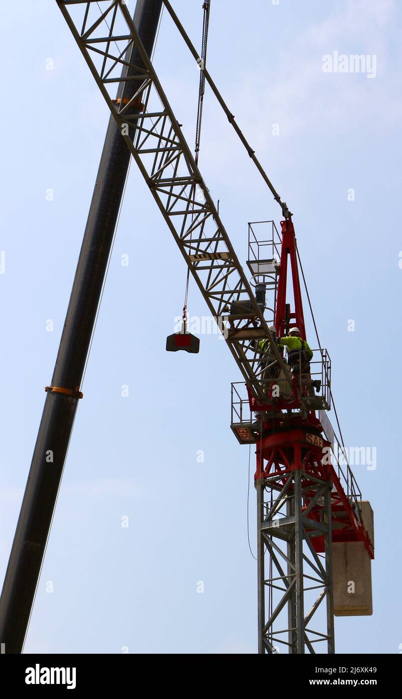 The hook block being lifted by a mobile crane to the workmen assembling ...
