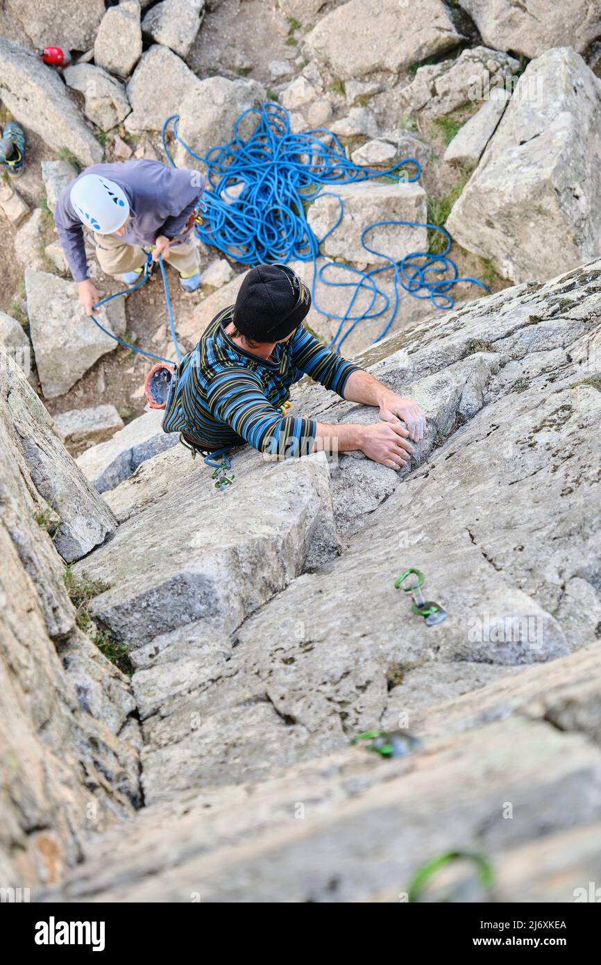 Top view of a man climbing a rock wall Stock Photo - Alamy