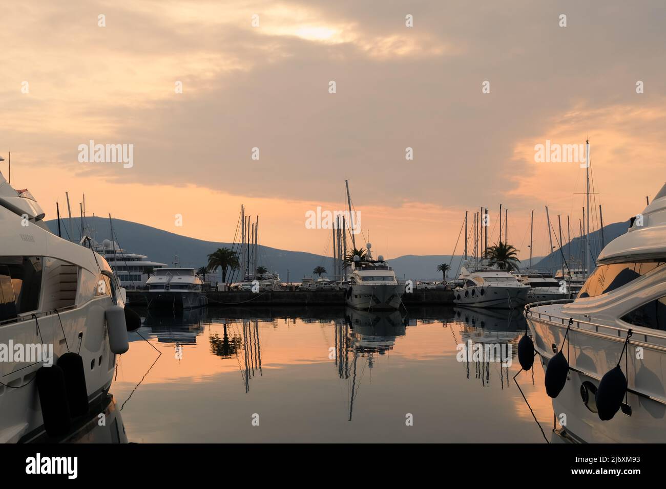 sunset sky reflected in water and yachts in the port Stock Photo - Alamy