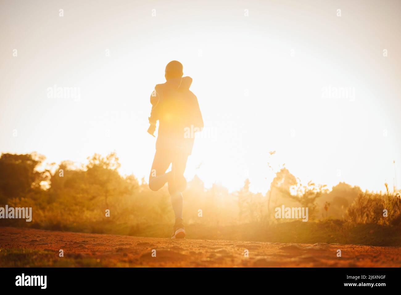 A Kenyan runner runs at sunrise in the city of Iten in Kenya. The ...