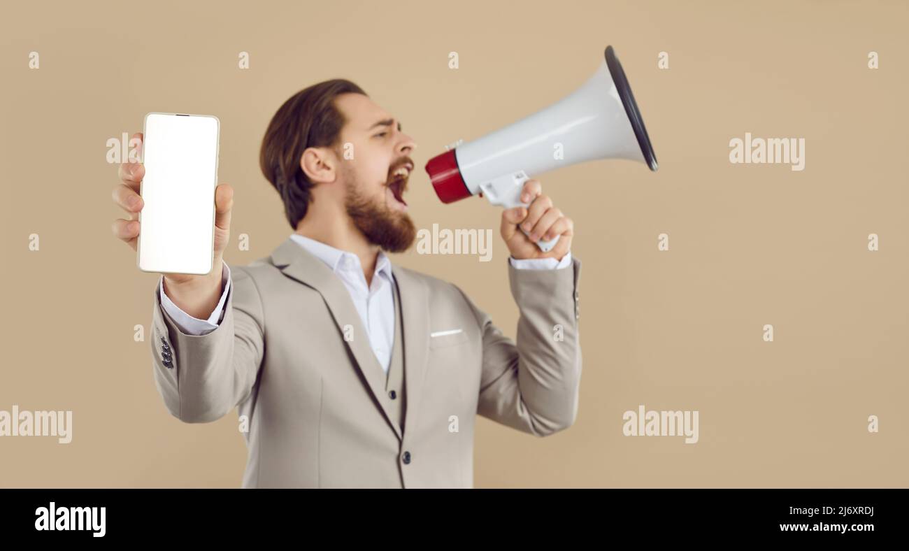 Man with loudspeaker makes loud announcement showing mobile phone with ...
