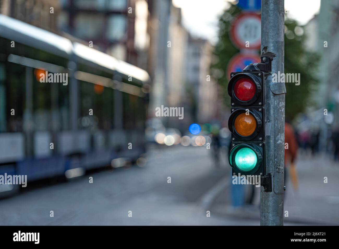blurred view of city traffic with traffic lights, in the foreground a ...