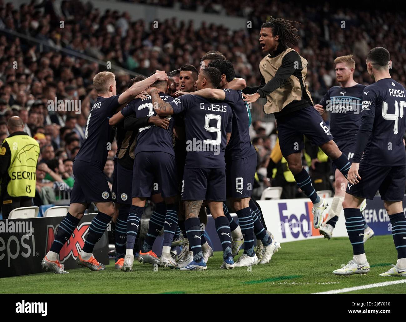 Manchester City's Riyad Mahrez is mobbed by team mates after scoring ...
