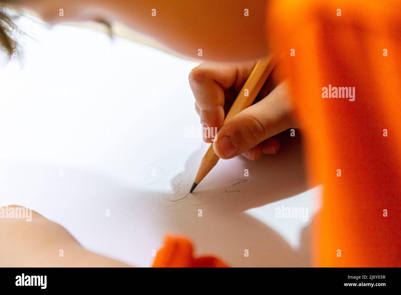 Little boy scribbling with pen on paper Stock Photo - Alamy