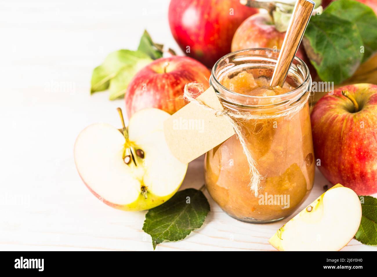 Apple jam with fresh apples on white background Stock Photo - Alamy