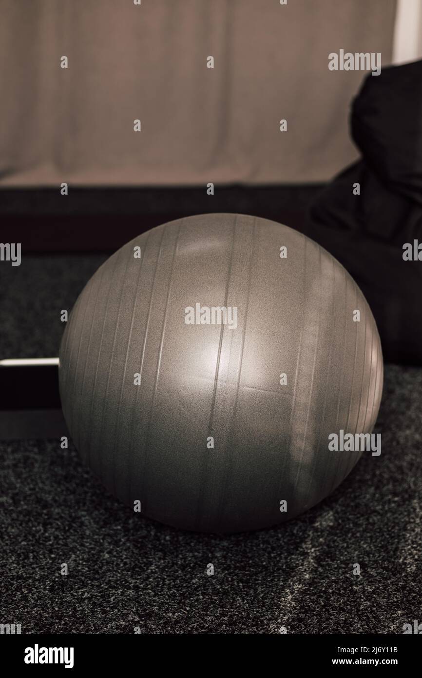 A grey large fitness ball lies in the gym Stock Photo - Alamy