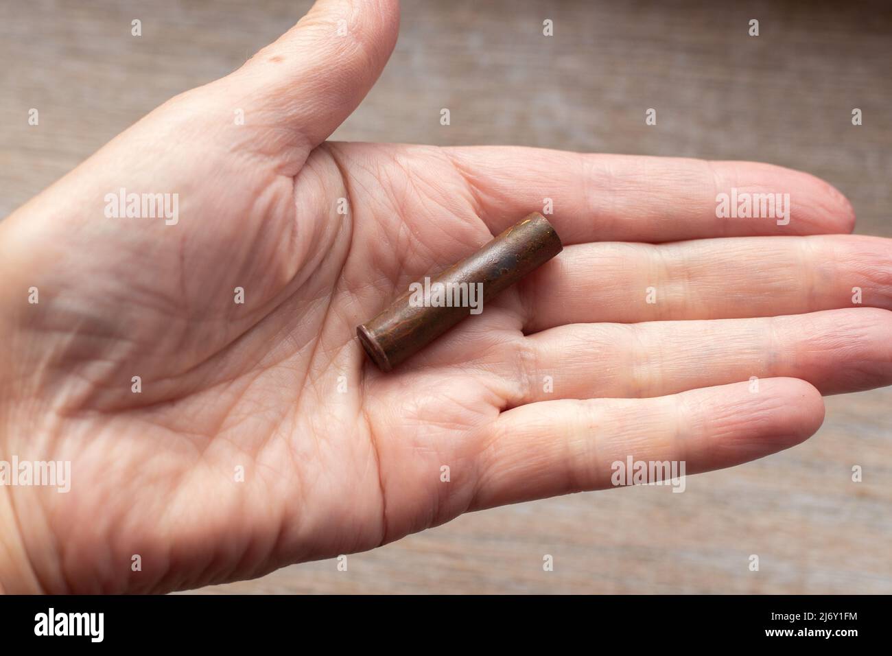 A cartridge case from an old Nagan revolver cartridge in the palm of ...