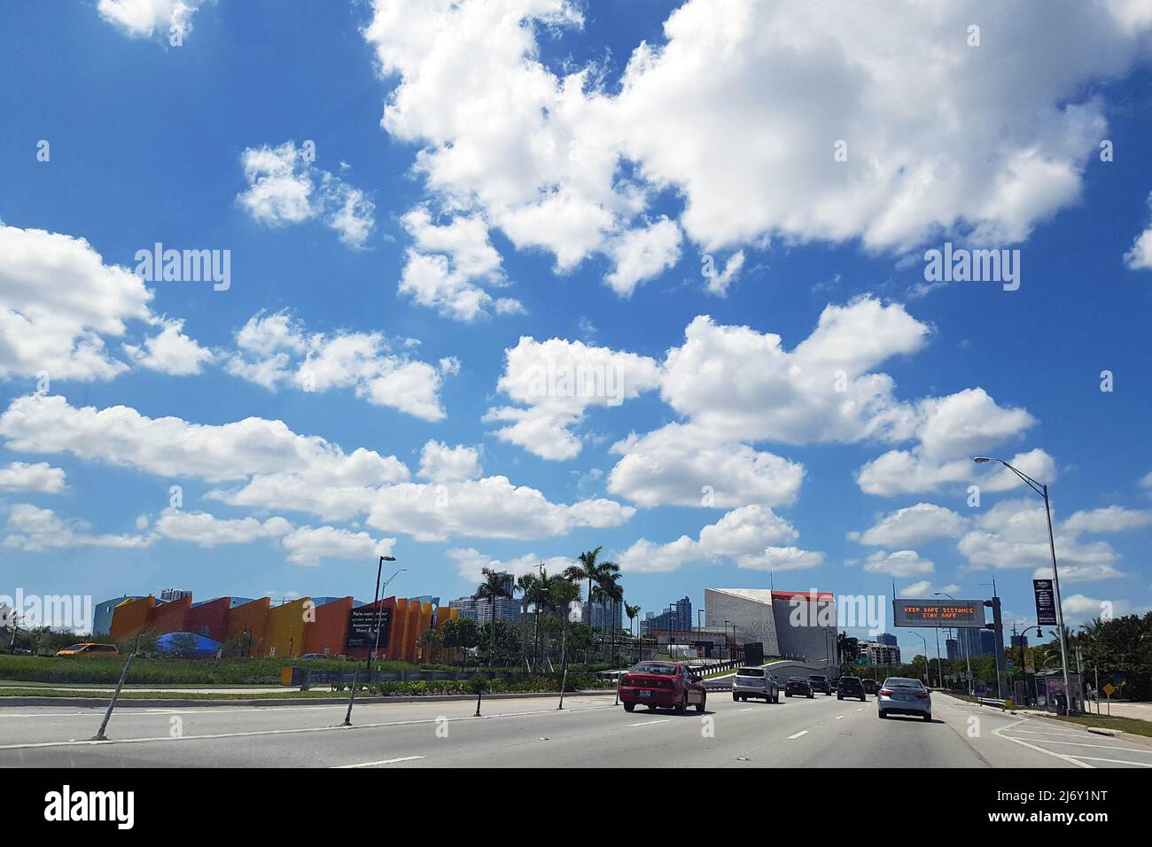 Entry into the city on the highway in sunny calm weather with clouds ...