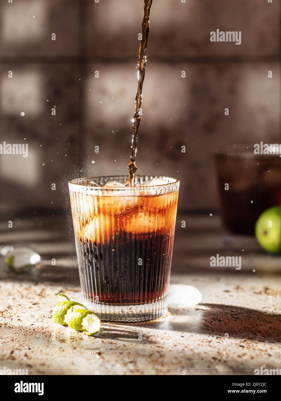 Fizzy iced Cola is pouring into glass, party concept Stock Photo - Alamy