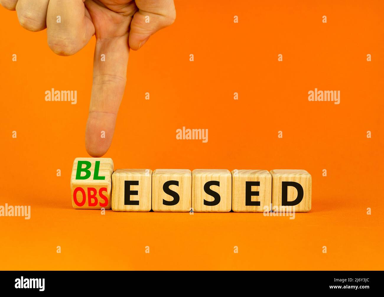 Blessed or obsessed symbol. Businessman turns wooden cubes and changes ...