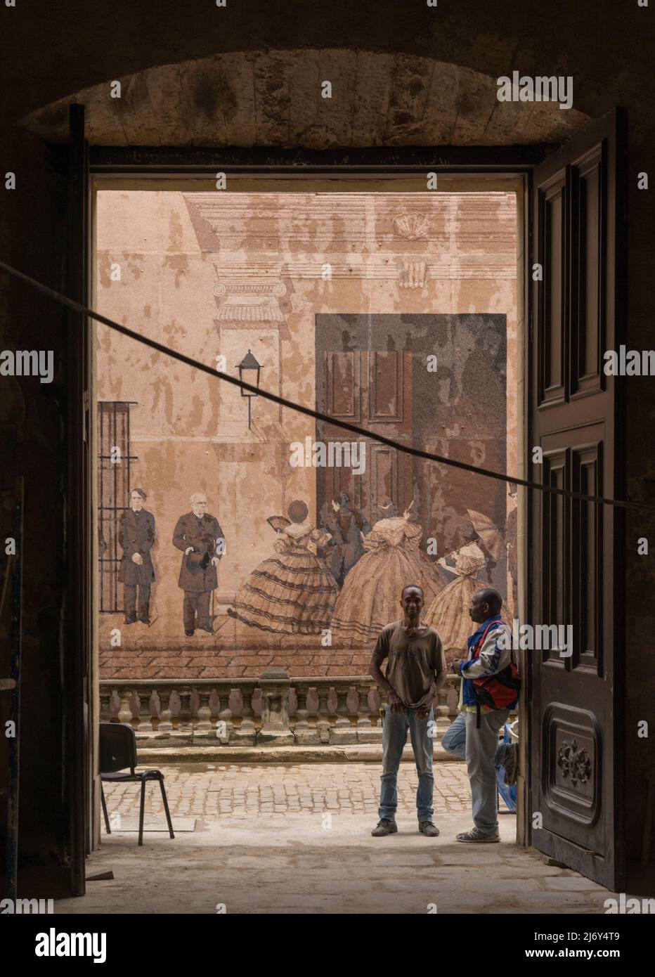 January 8, 2016 - Havana, Cuba: Two men stand in the doorway of an ...