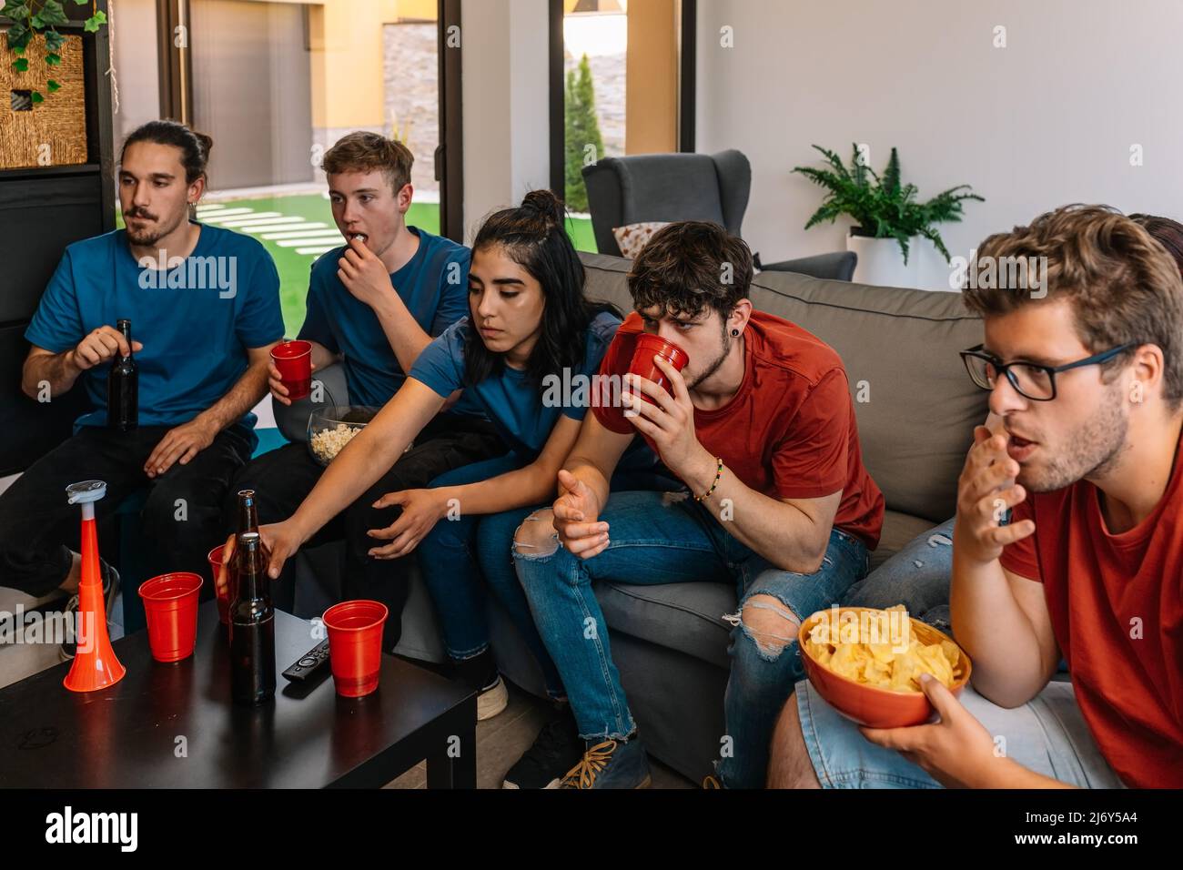 friends, house party watching television. group watching a movie or ...