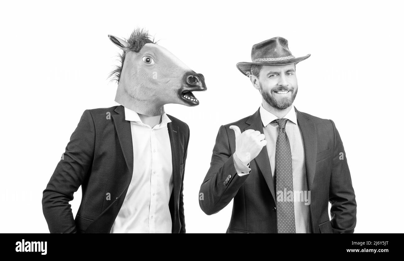 Happy cowboy man point finger at businessman wearing horse head ...