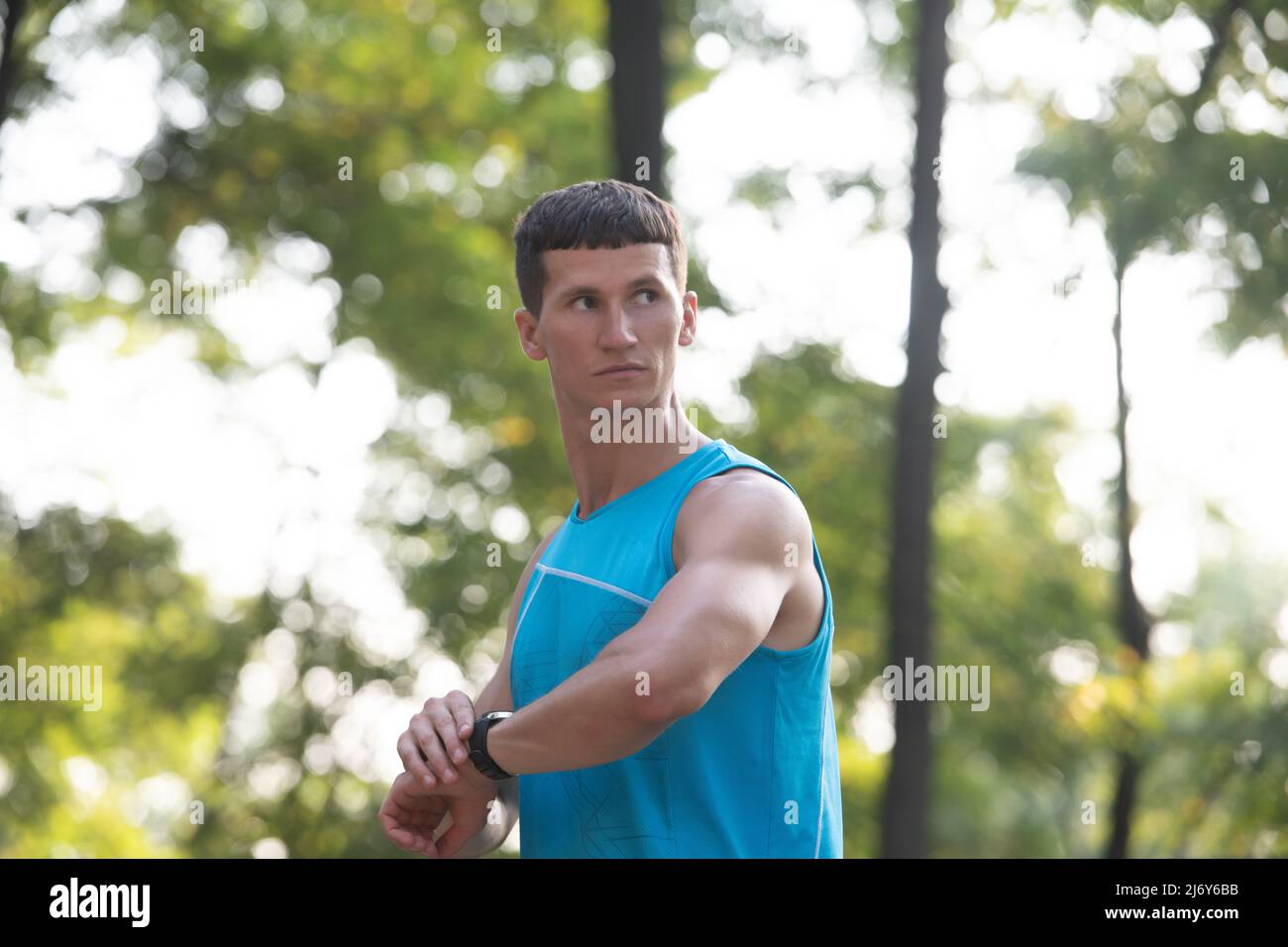 man jogger in activewear checking time on smartwatch Stock Photo - Alamy