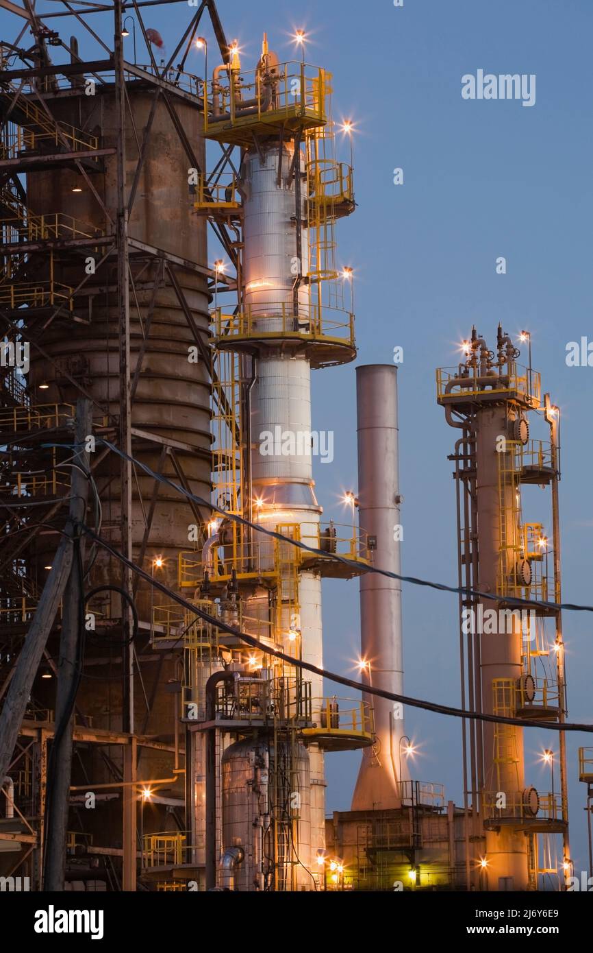 Oil and gas refinery with towers illuminated at dusk, Montreal East ...