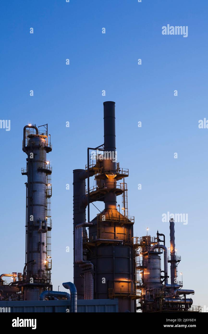 Oil and gas refinery with towers illuminated at dusk, Montreal East ...