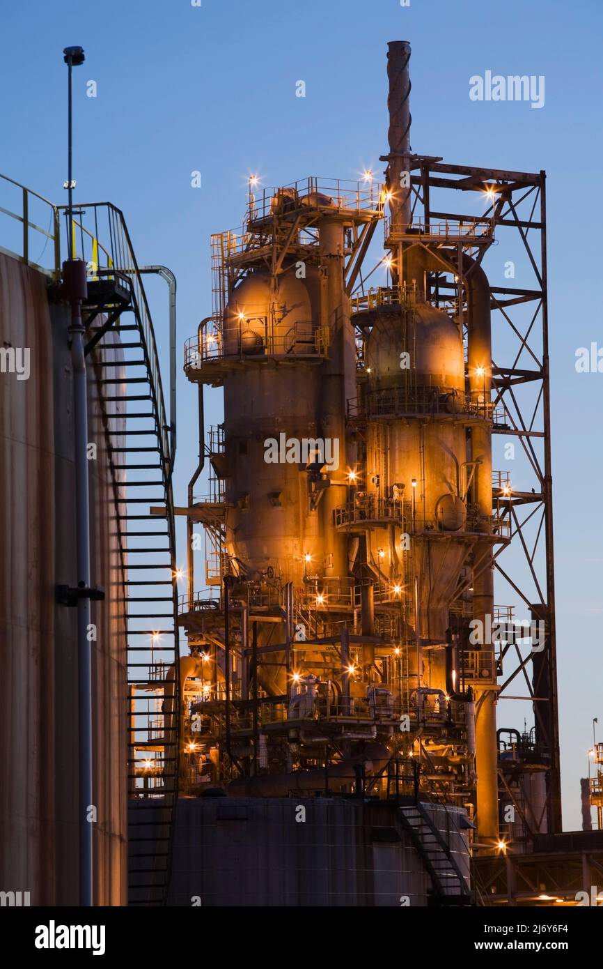 Oil and gas refinery with towers illuminated at dusk, Montreal East ...