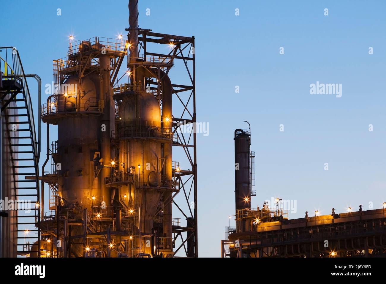 Oil and gas refinery with towers illuminated at dusk, Montreal East ...