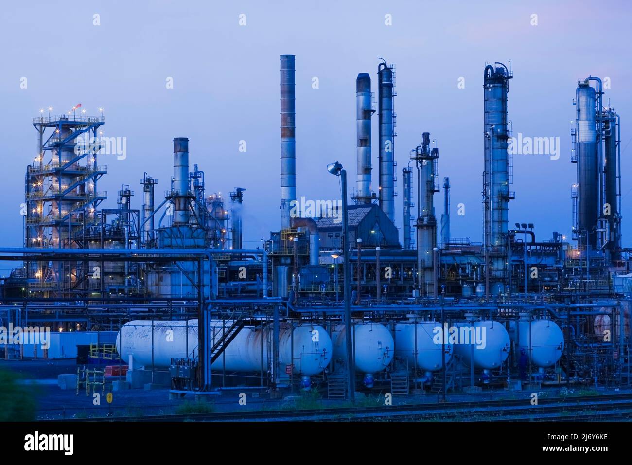 Oil and gas refinery with storage tanks and towers at dusk, Montreal ...