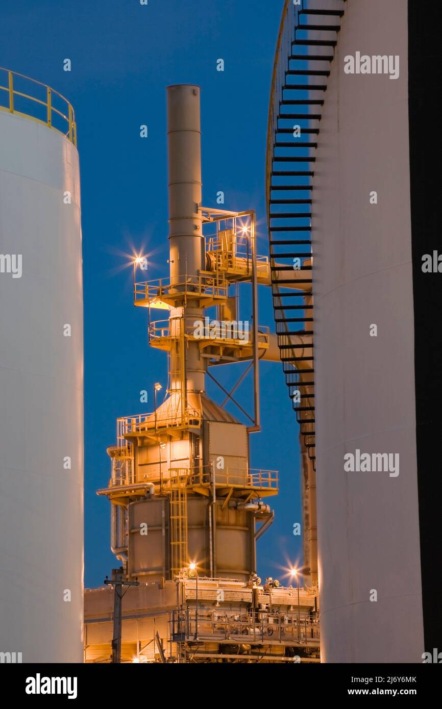 Oil and gas storage tanks with towers at refinery at dusk, Montreal ...