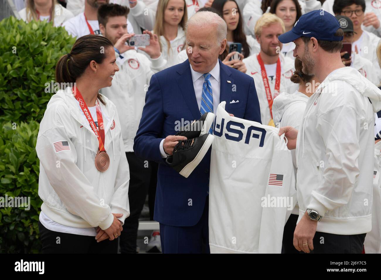 President Joe Biden is presented with Team USA jersey and sneakers ...