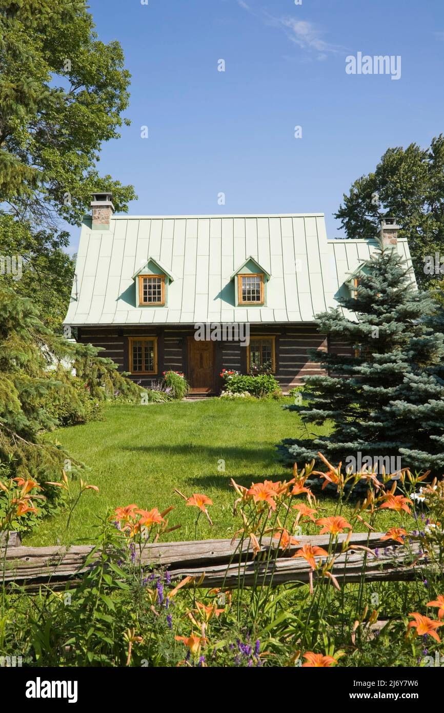 Old 1800s Canadiana style log home with landscaped front yard protected ...