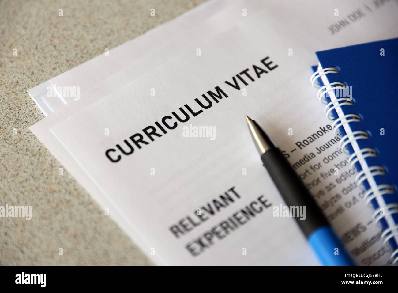 Top view of stack of office documents including resume and cv forms on ...