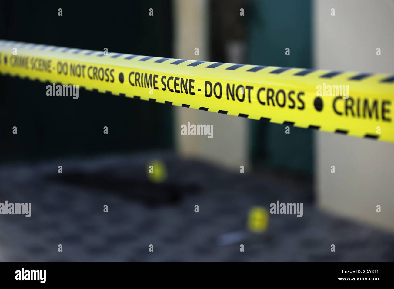 Crime scene tape for covering the area cordon. Yellow tape with blurred ...