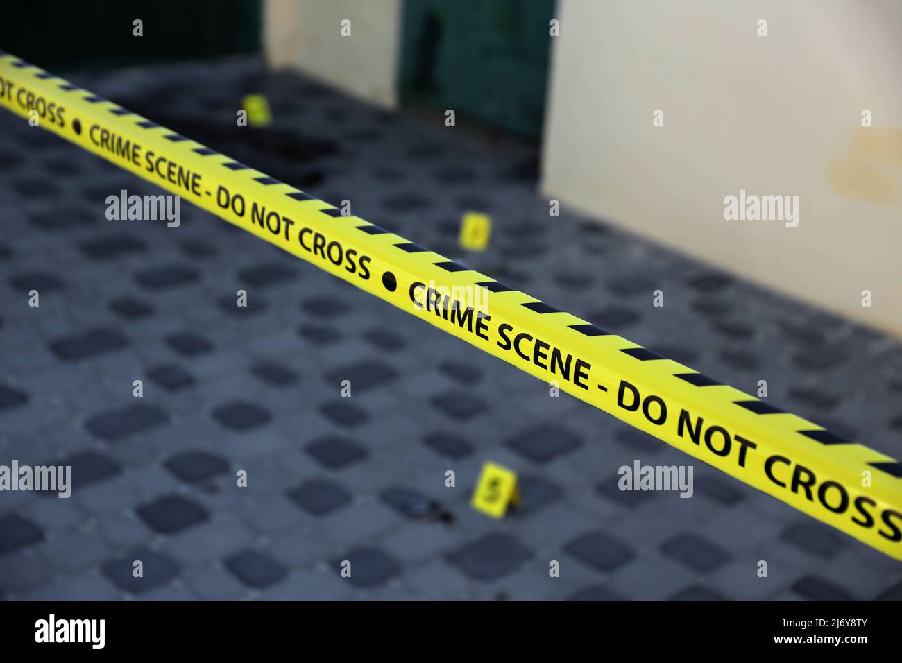 Crime scene tape for covering the area cordon. Yellow tape with blurred ...