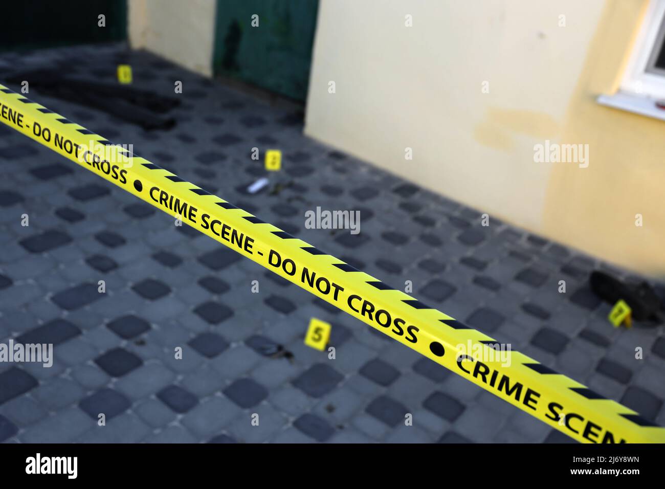 Crime scene tape for covering the area cordon. Yellow tape with blurred ...