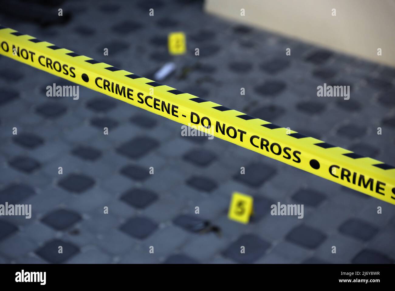Crime scene tape for covering the area cordon. Yellow tape with blurred ...