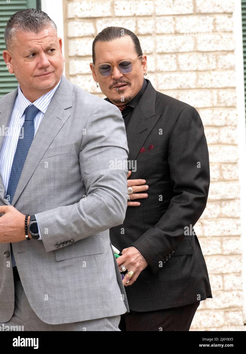 Johnny Depp acknowledges the cheers of his fans as he goes outside ...