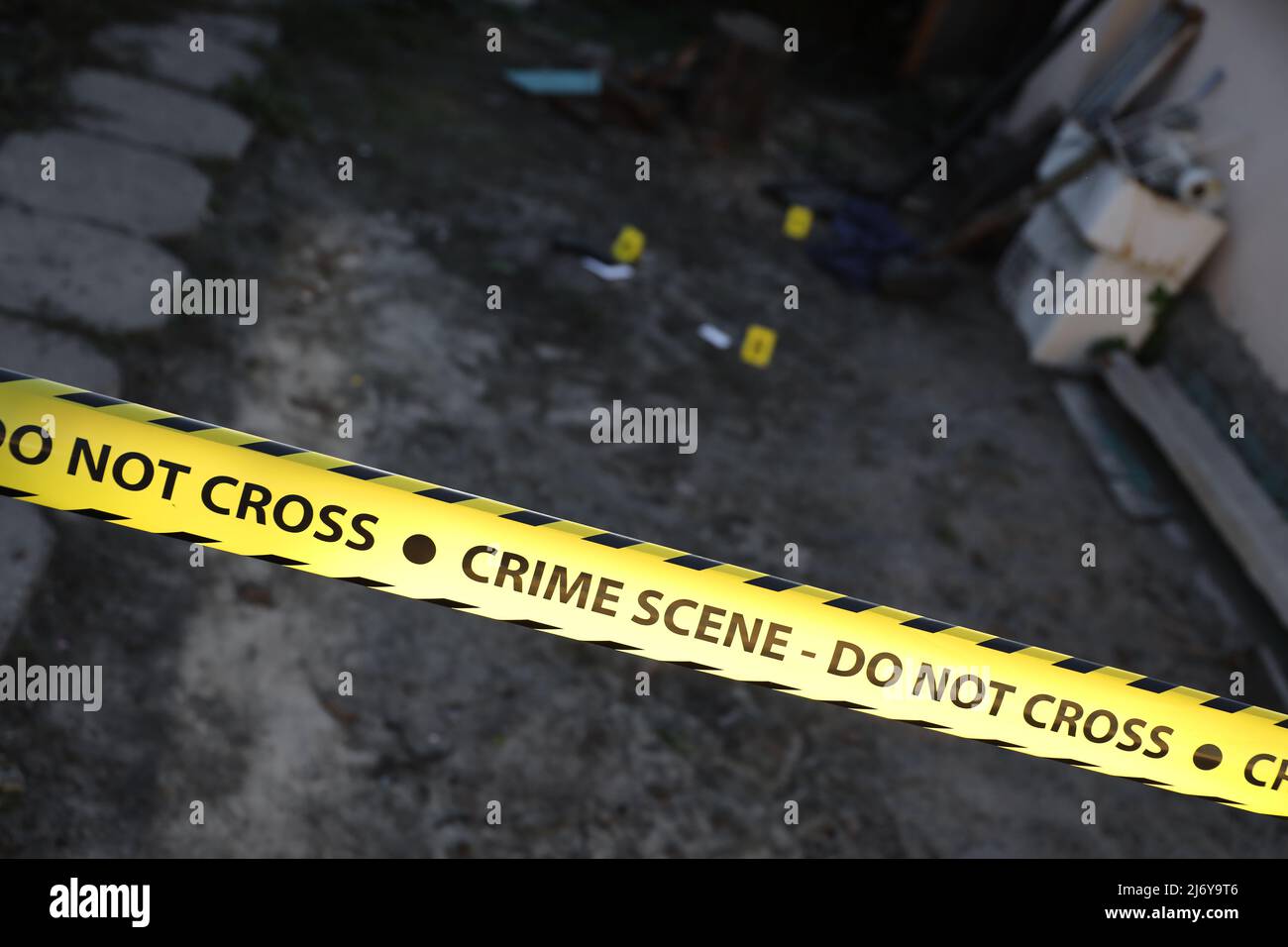 Crime scene tape for covering the area cordon. Yellow tape with blurred ...