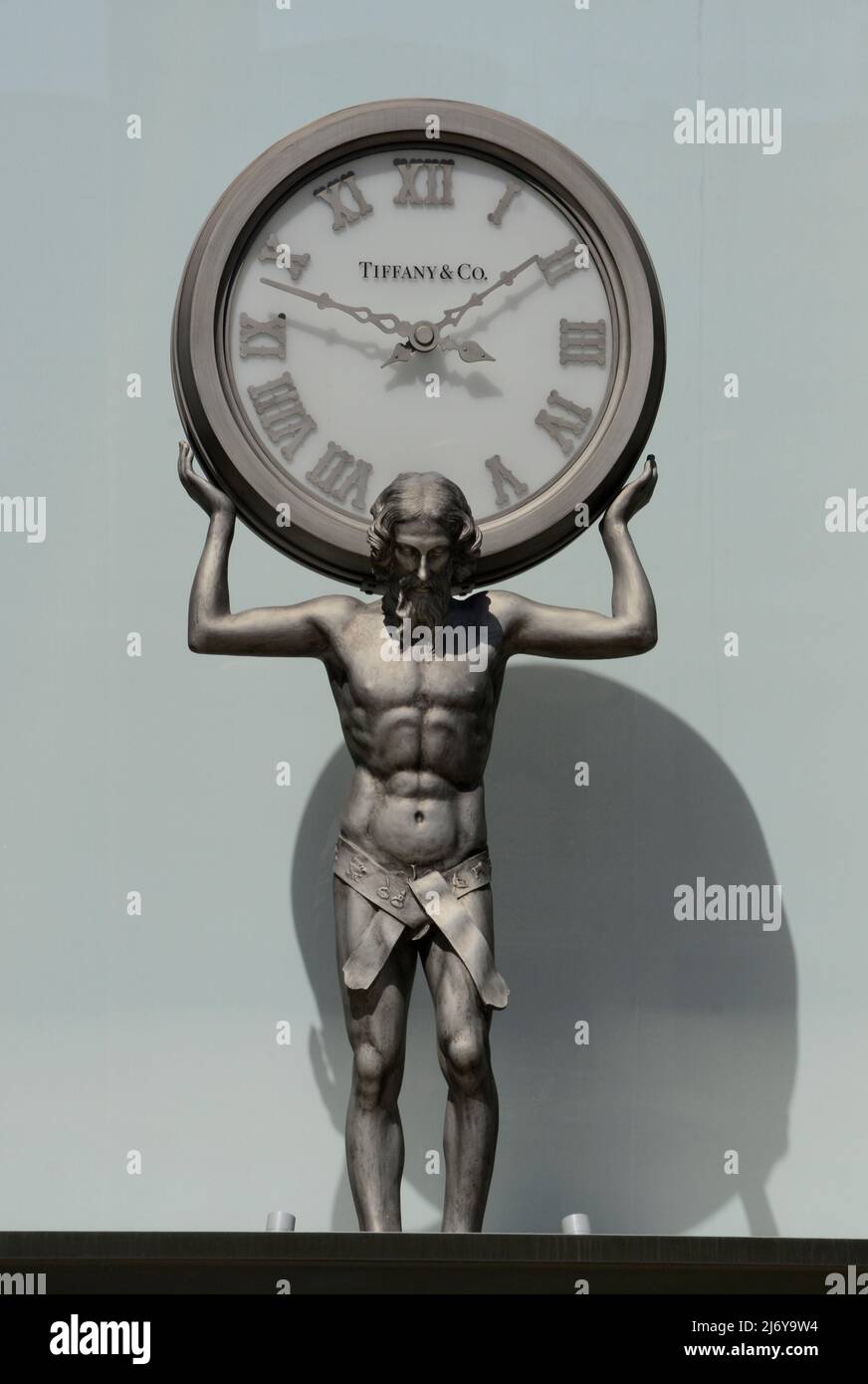 A clock in the form of Greek god Atlas holding the world in front of a ...