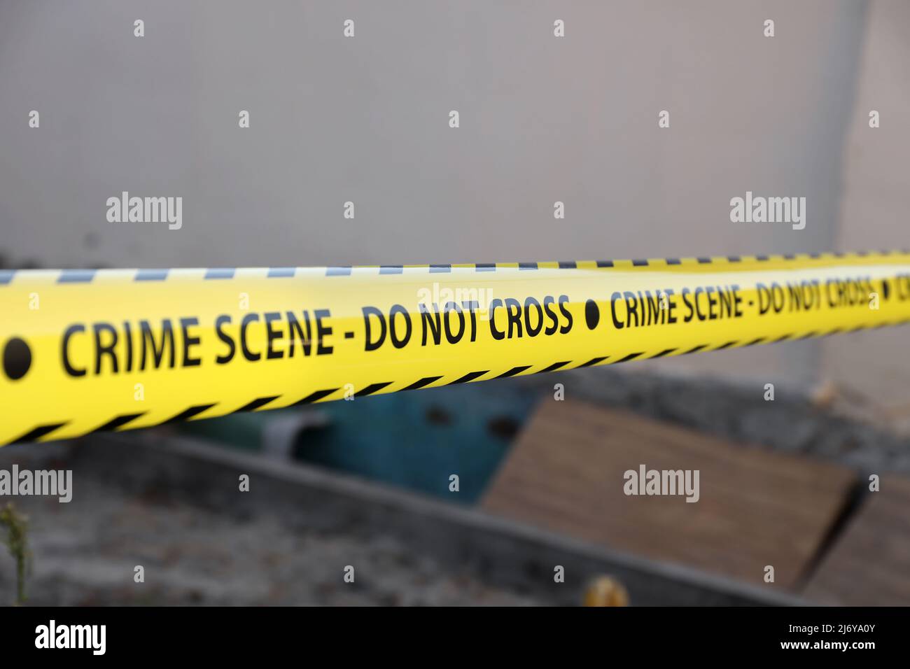 Crime scene tape for covering the area cordon. Yellow tape with blurred ...