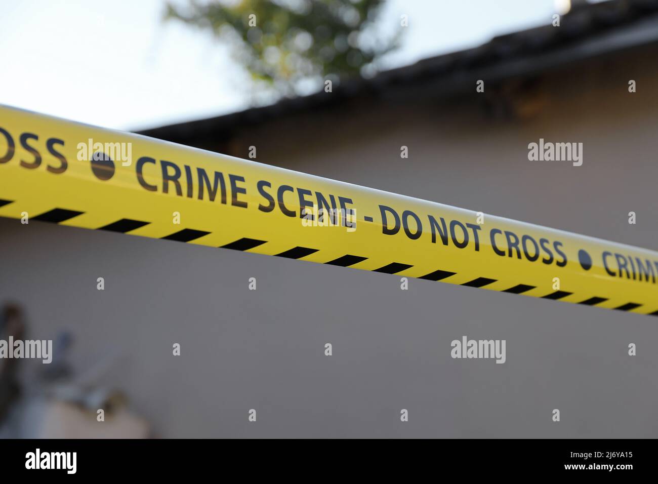 Crime scene tape for covering the area cordon. Yellow tape with blurred ...