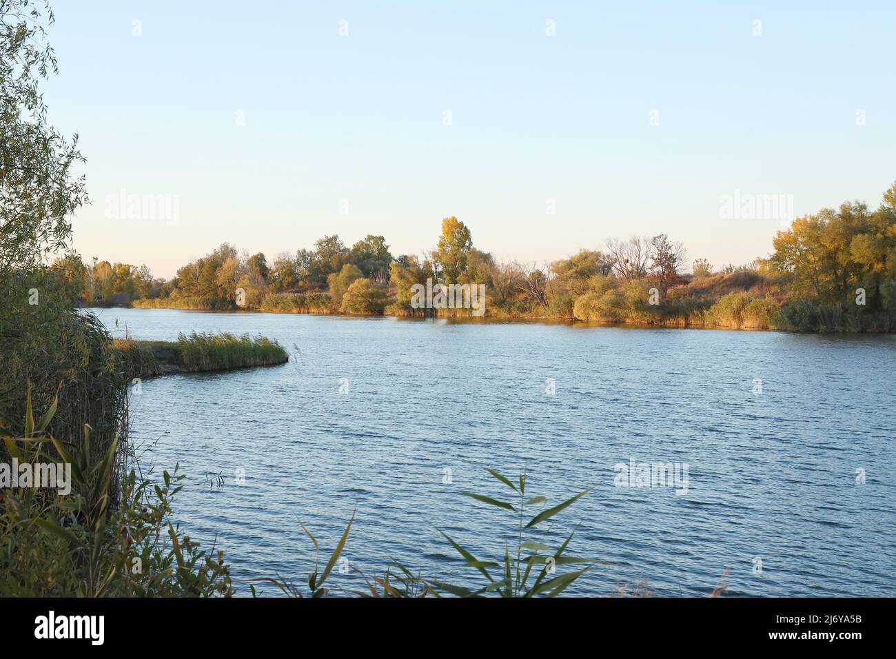 Beautiful autumn landscape with lake and multicoloral trees ...