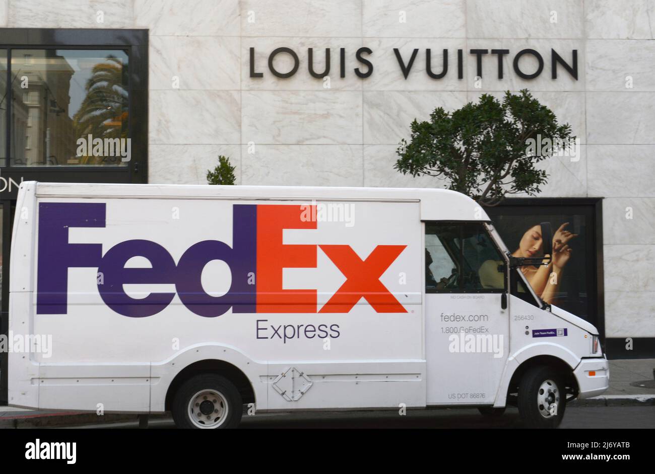 A Federal Express (FedEx) truck delivers packages to a Louis Vuitton ...