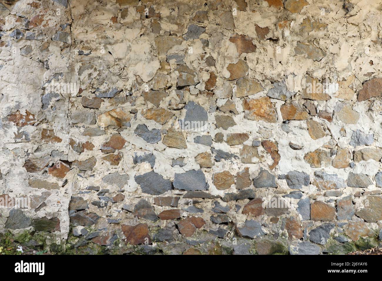 Texture of a stone wall with many big brown and grey stones armed with ...
