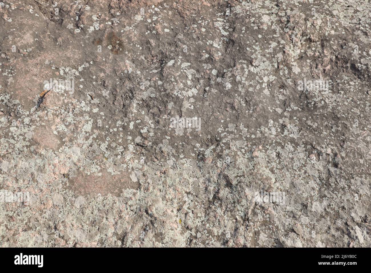 Closeup of the rough stone texture of a big rock surface for natural ...