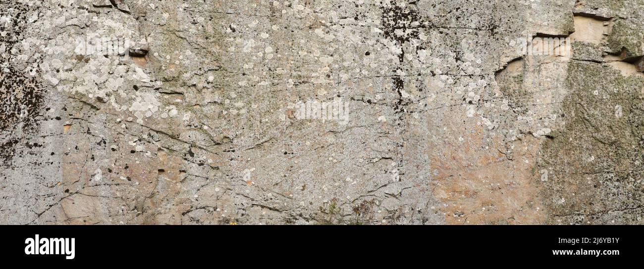 Closeup of the rough stone texture of a big rock surface for natural ...