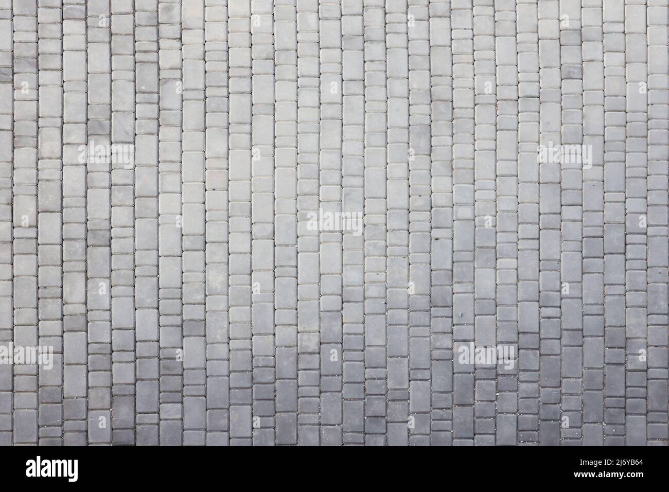 Gray color paving slabs in the pedestrian street sidewalk. Rough ...