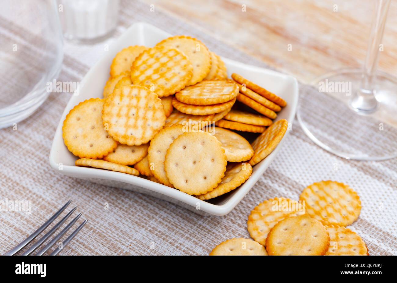 Crispy disc-shaped lightly salted crackers in plate on table Stock ...